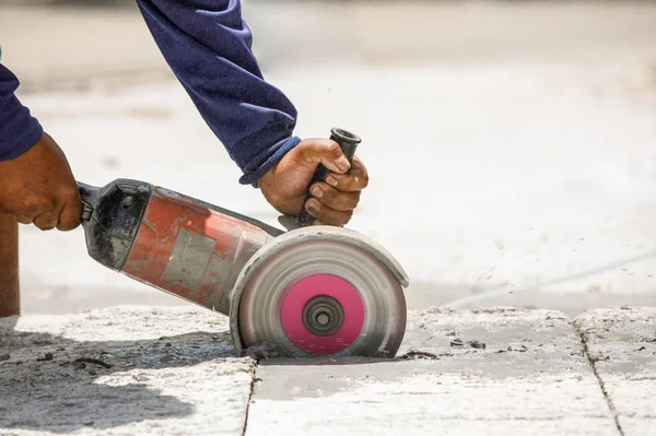 Worker using tool to cut concrete floor — Stock Photo © Surabky #157764354