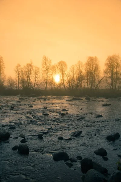 A beautiful, colorful misty morning scenery at the river. Norwegian ...