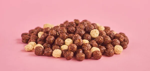 Pile of beige and brown round cornflakes on pink background - Stock ...