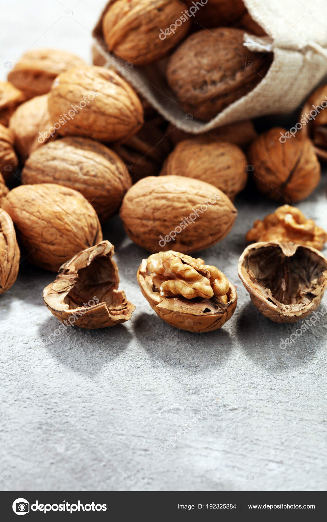 Walnut kernels and whole walnuts on rustic old table Stock Photo by ...