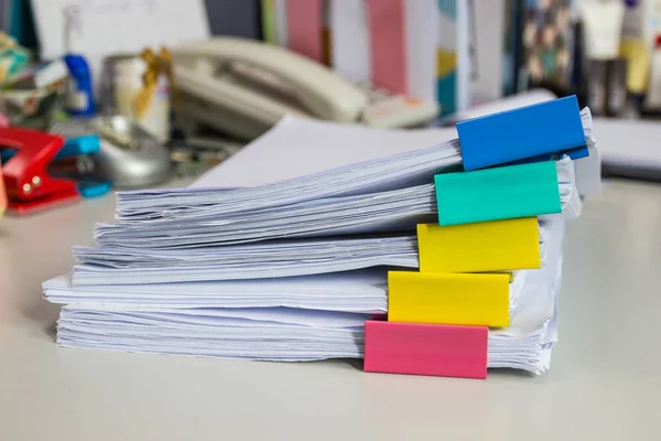 Stack of papers documents in archives files with paper clips on desk at ...