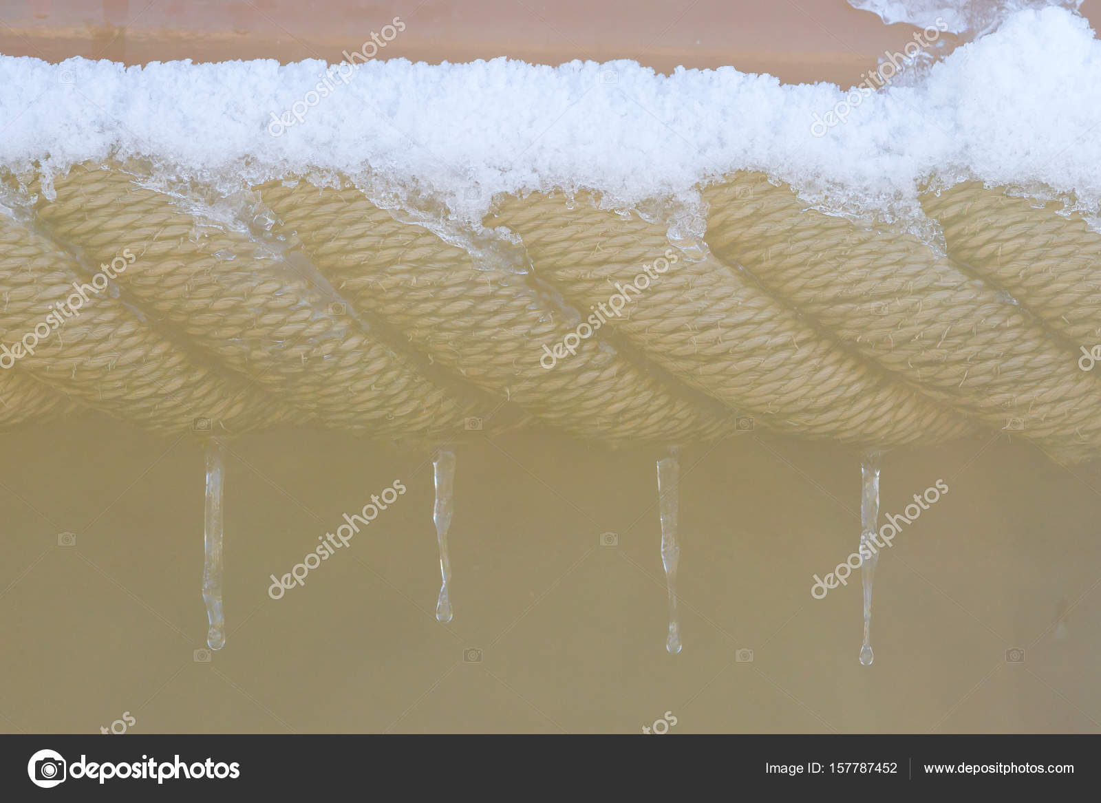 Nautical rope curving coil covered with snow and ice Stock Photo by ...