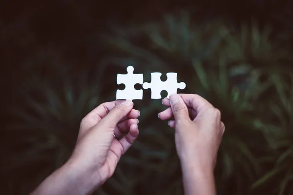 Hands people connect couple puzzle piece together with sun light ...