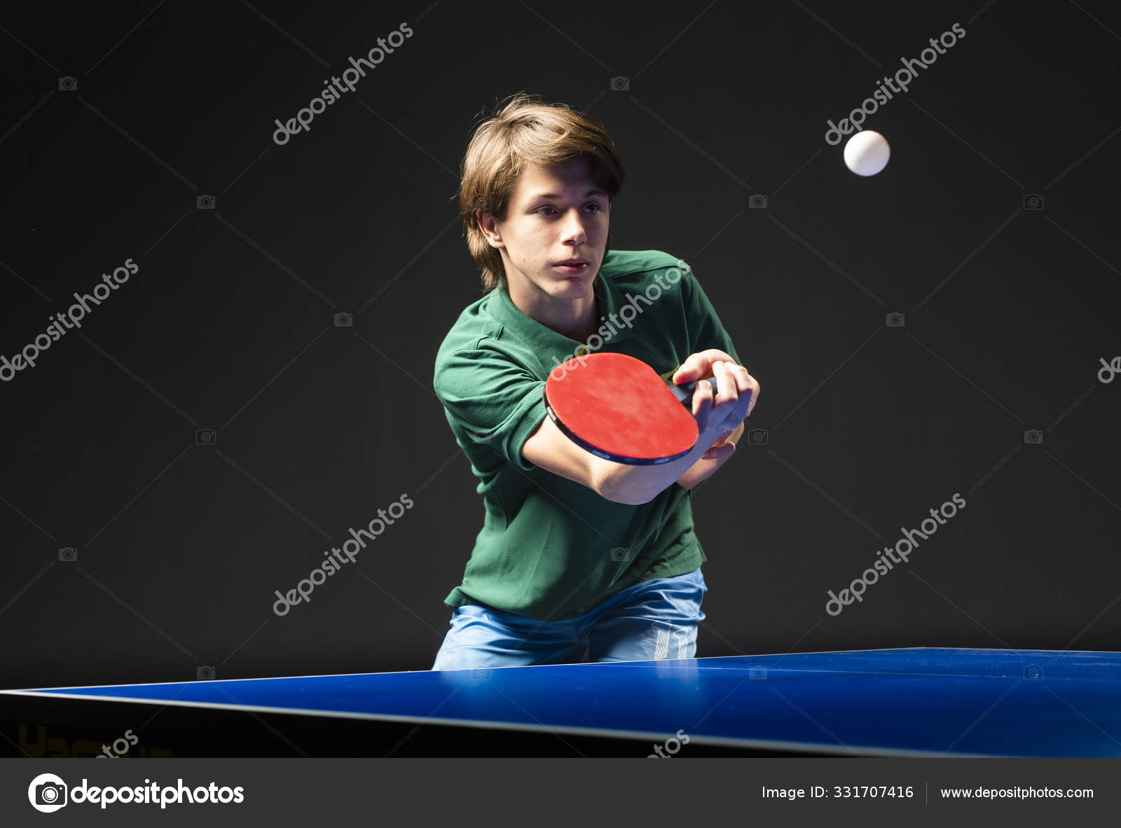 A boy playing ping-pong (table tennis) — Stock Photo © fotokostic #331707416