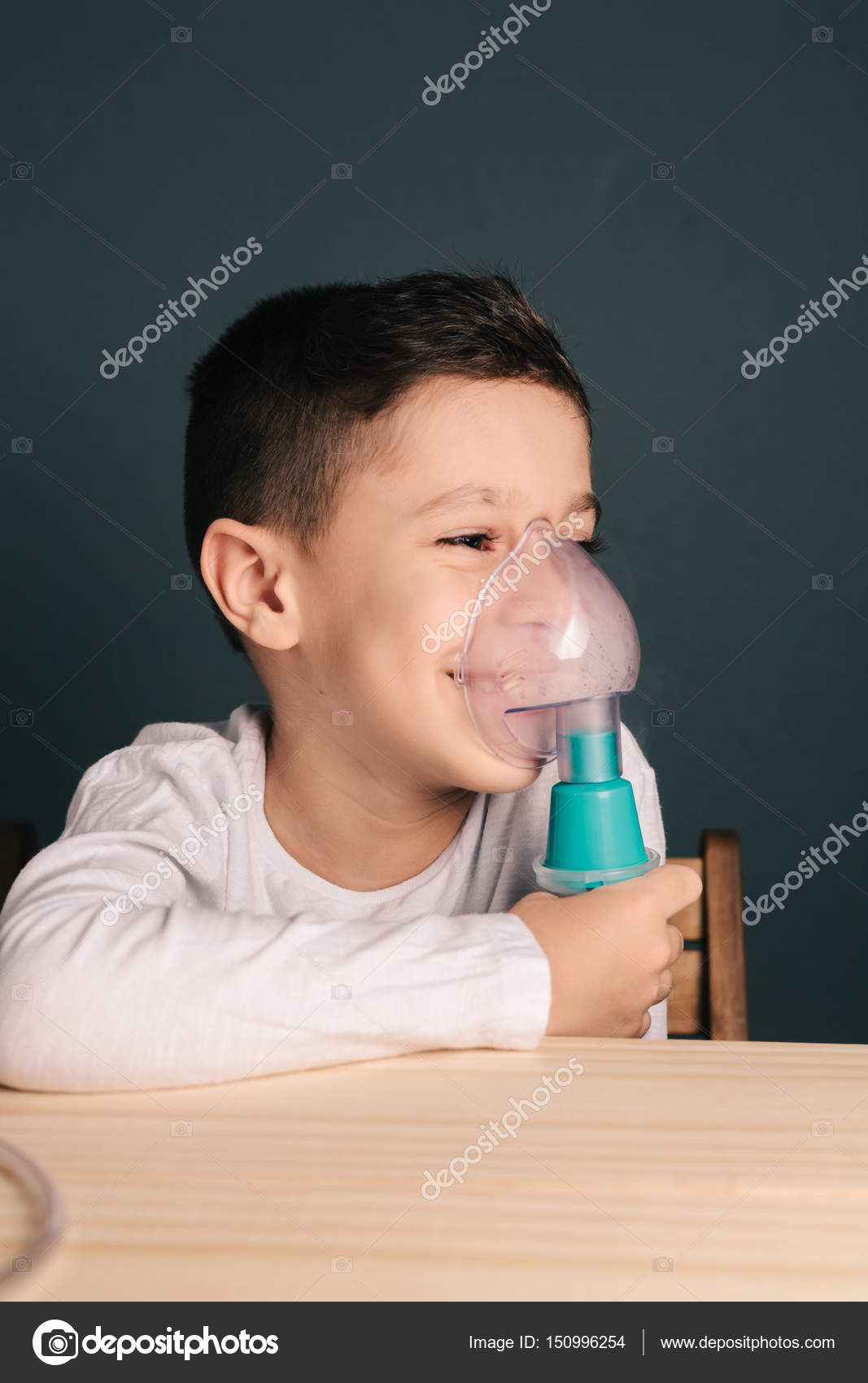 Beautiful sick boy inhalation therapy by the mask of inhaler. Image of ...