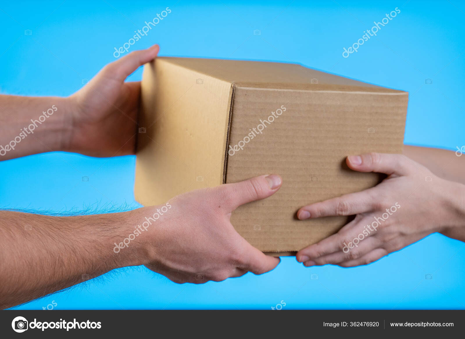 Two hands taking a box gift on blue background Stock Photo by ...