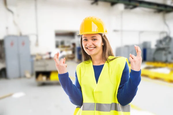 Young female engineer making good luck gestur - Stock Image - Everypixel