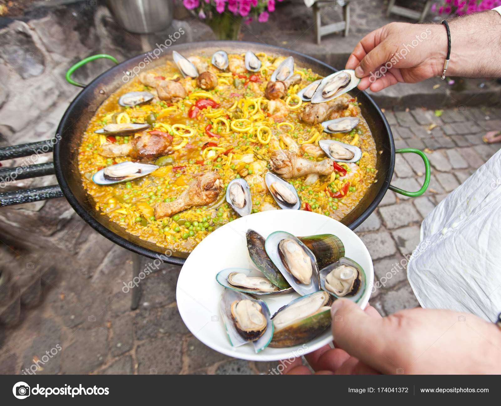Man Preparing Paella Spanish Rice Dish Adding Mussels Stock Photo by ...