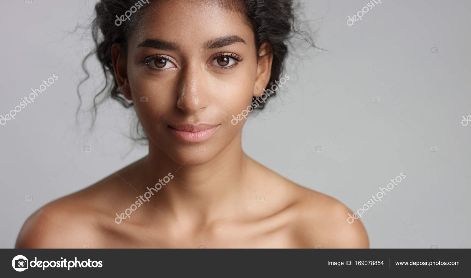 Happy serene young woman with beautiful olive skin and curly hair ideal ...