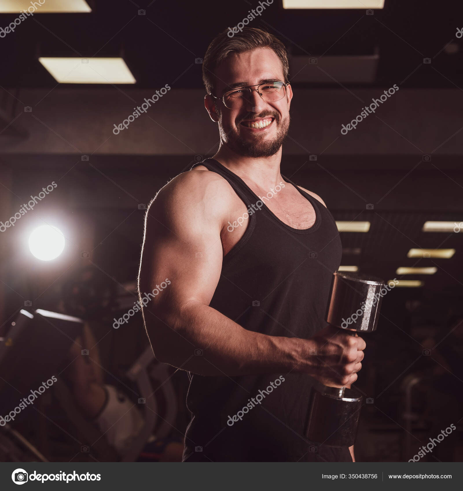 A man with an effort does an exercise for biceps and triceps with a ...