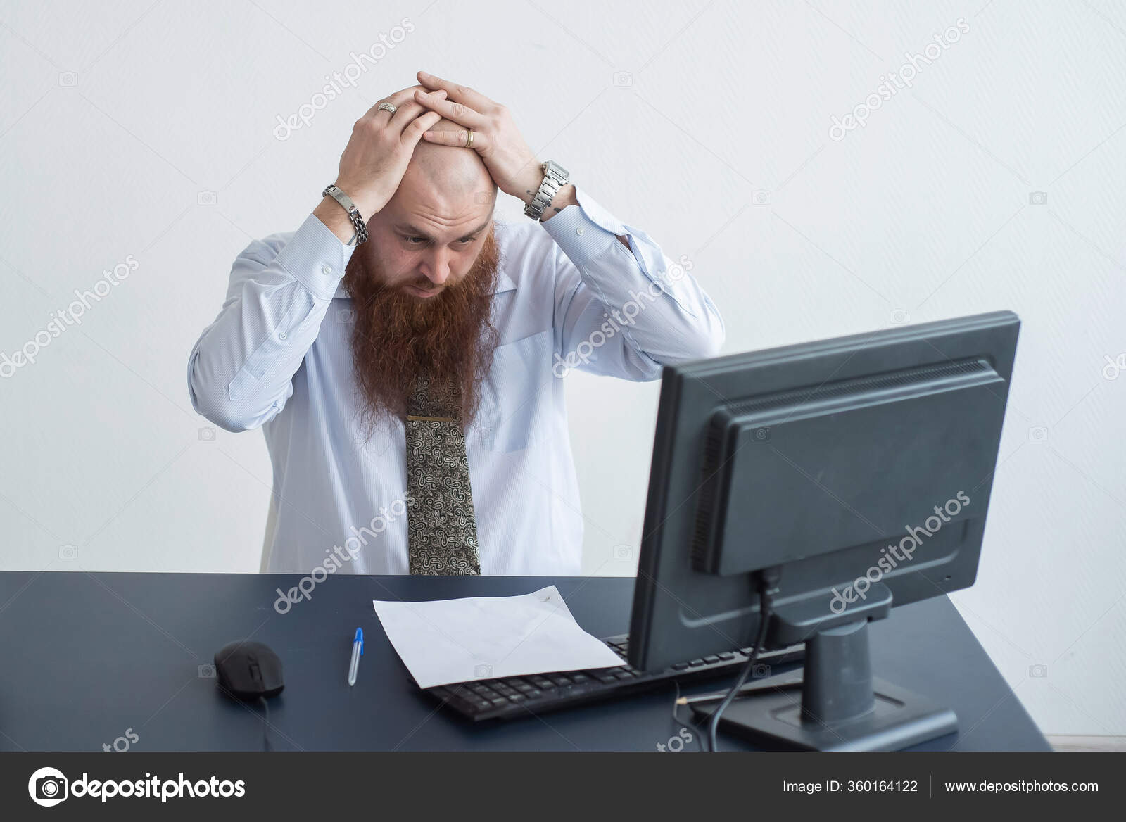 Problems for the office worker. A bald man in a white shirt sits at a ...