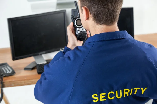 Security officer talking on walkie-talkie — Stock Photo ...