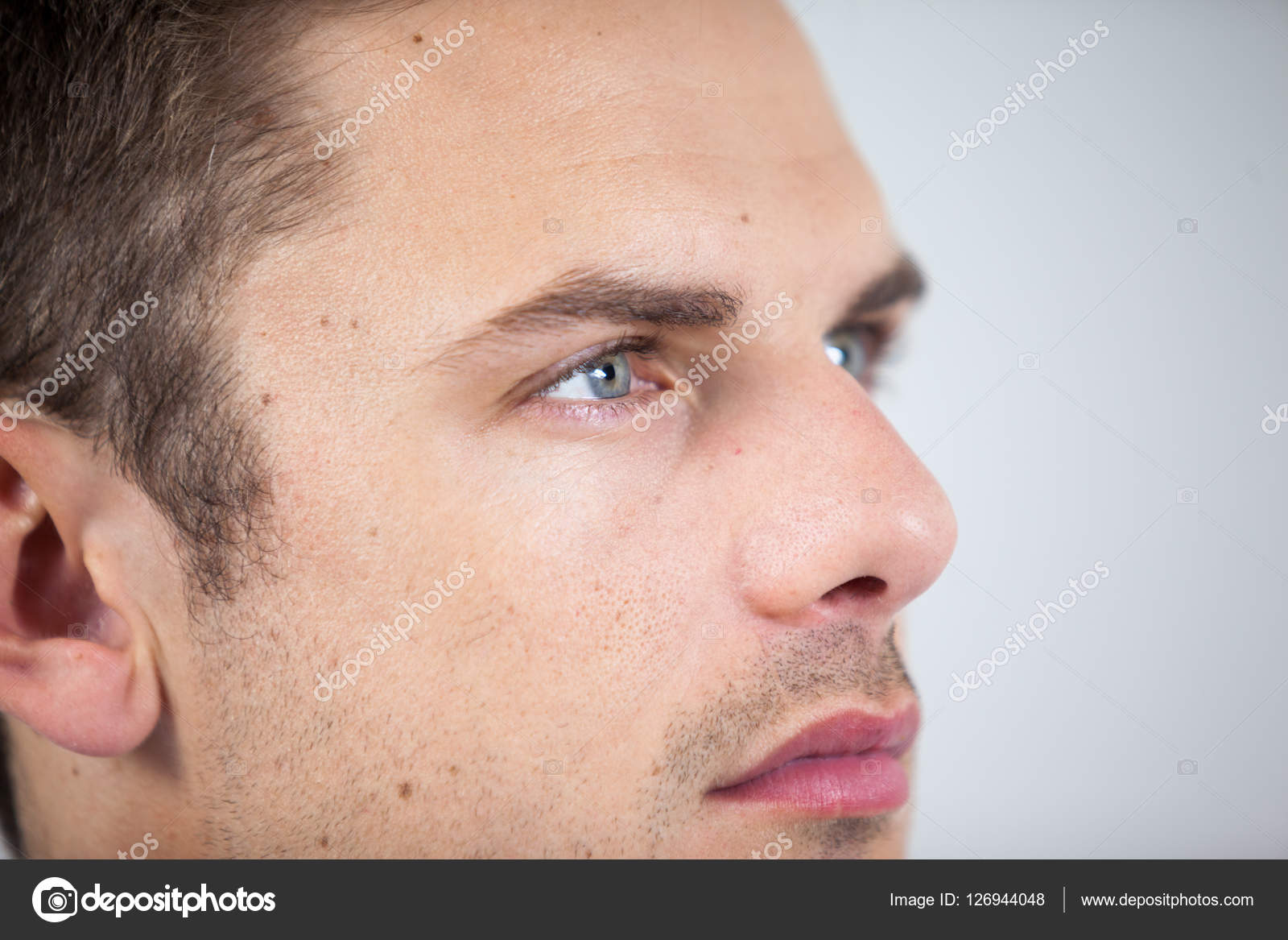 Man wearing contact lens Stock Photo by ©Wavebreakmedia 126944048