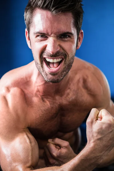 Excited shirtless athlete flexing muscles Stock Photo by ...