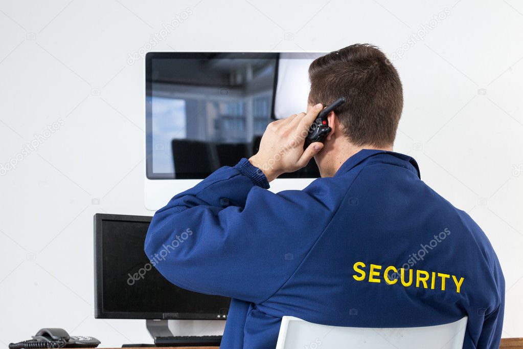Security officer talking on walkie-talkie — Stock Photo ...