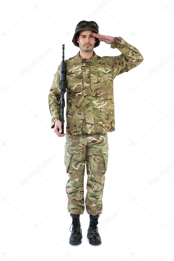 Soldier holding a rifle and saluting Stock Photo by ©Wavebreakmedia ...