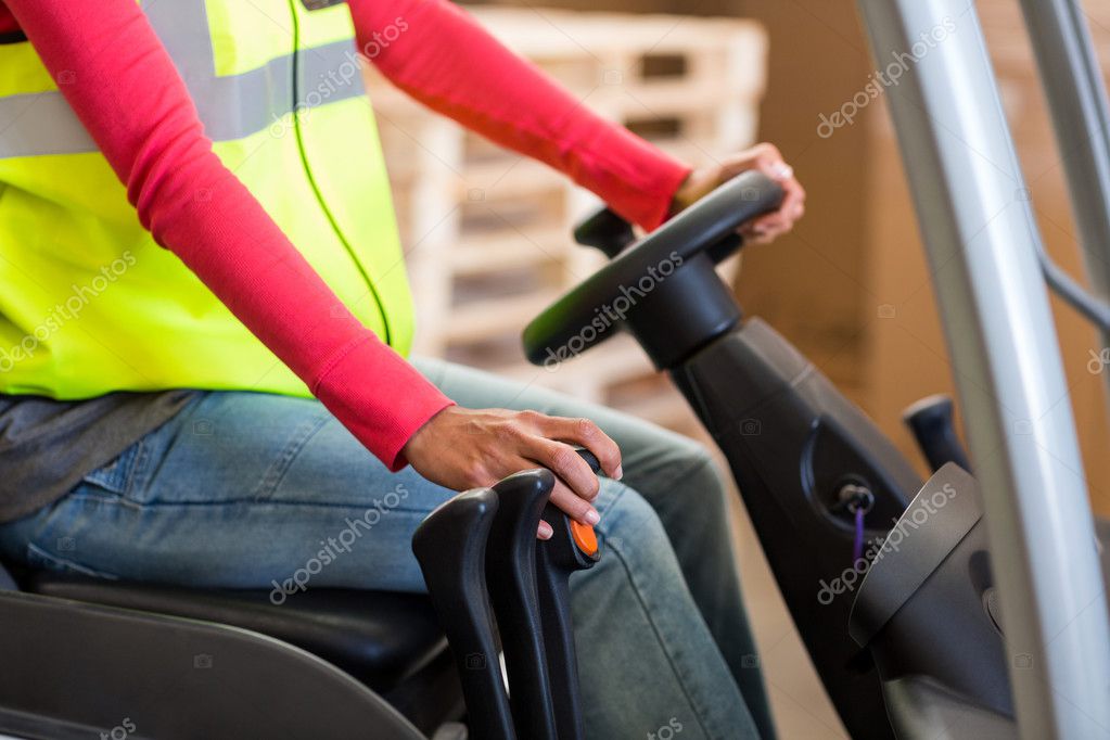 Warehouse worker using forklift — Stock Photo © Wavebreakmedia #127374898