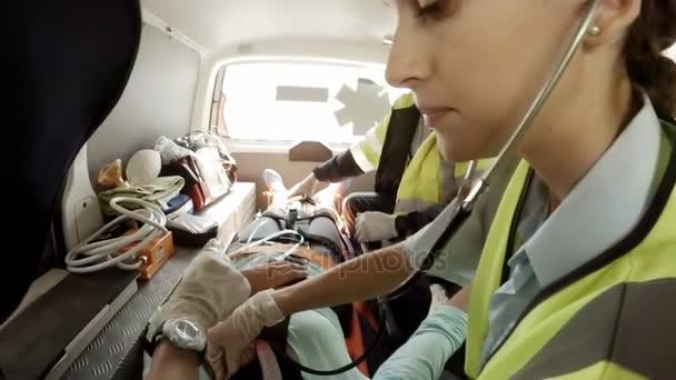 Paramedic using an external defibrillator during cardiopulmonary ...