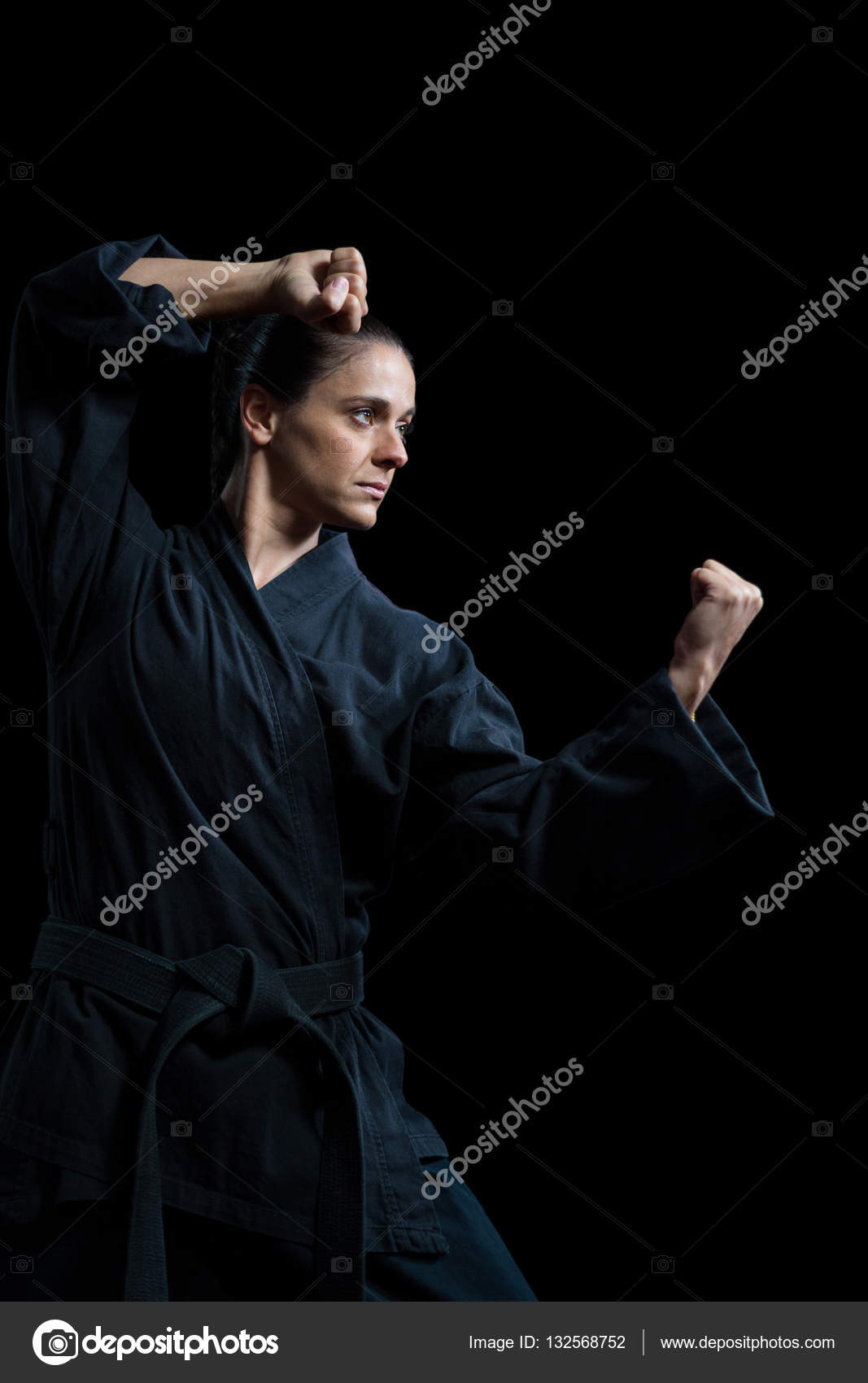 Female karate player performing karate stance Stock Photo by ...