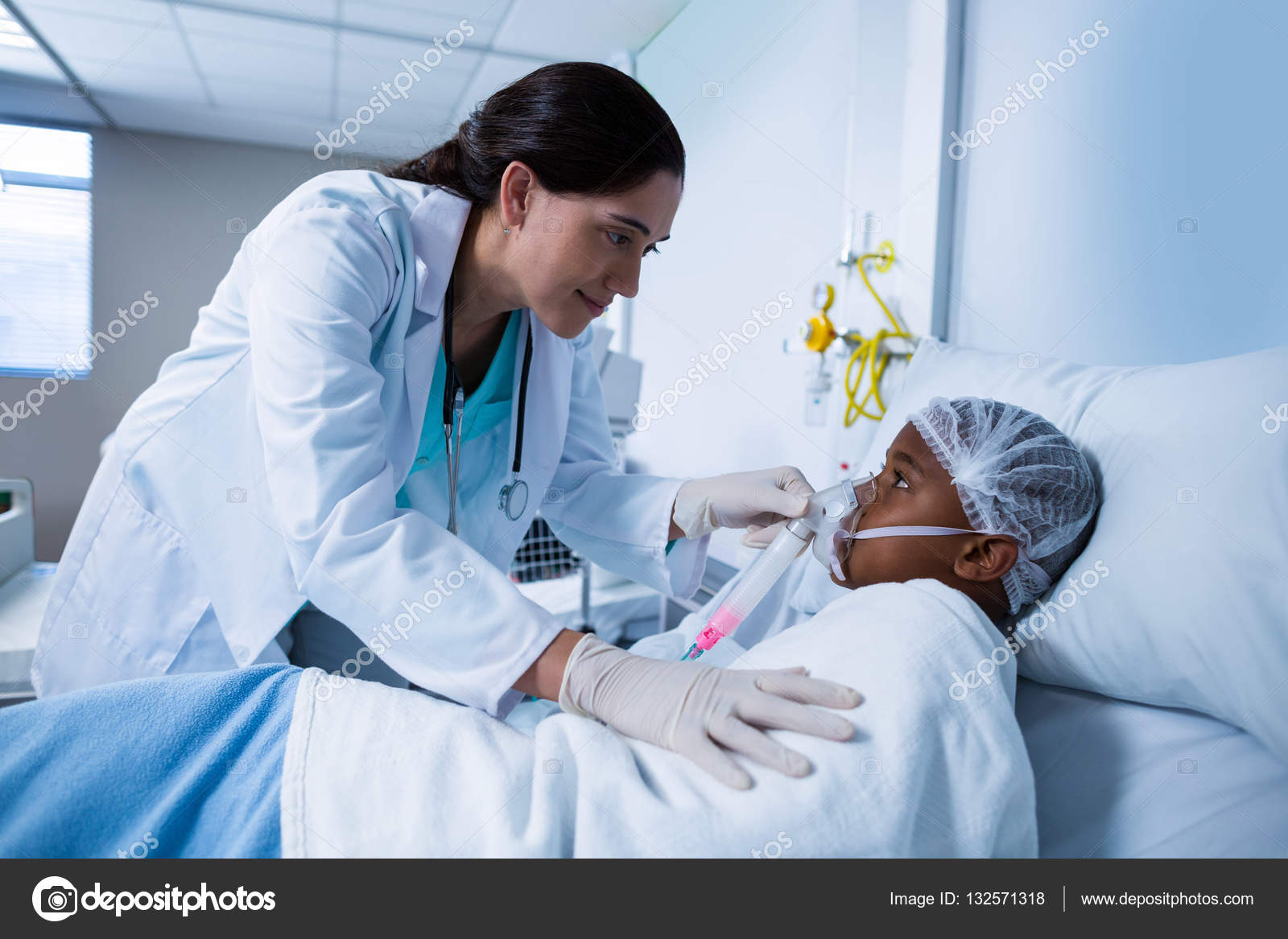 Doctor placing an oxygen mask on patient Stock Photo by ©Wavebreakmedia ...