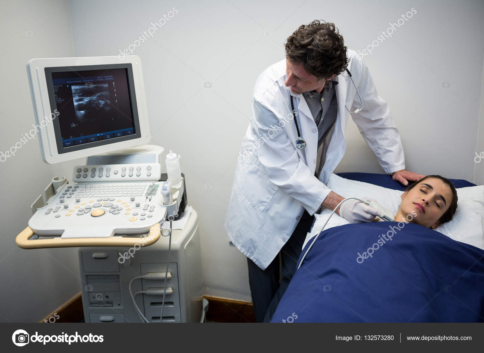 Doctors performing a doppler sonography on patient Stock Photo by ...