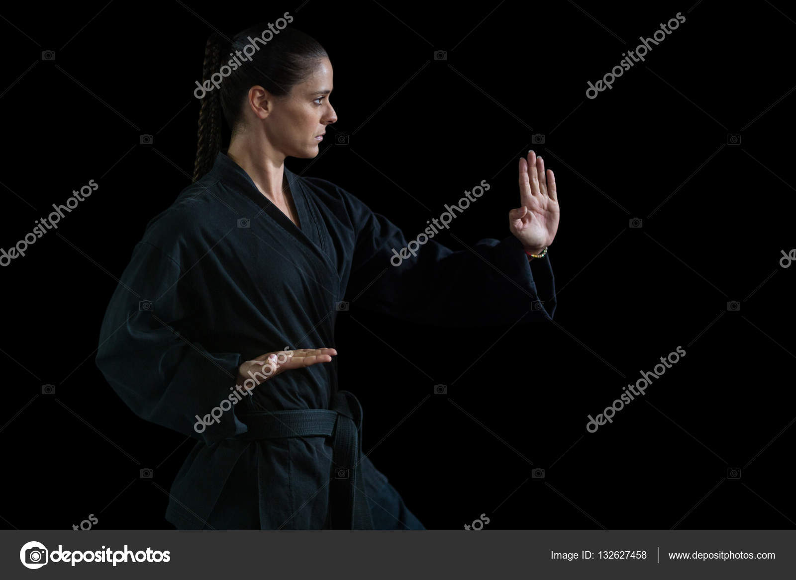 Female karate player performing karate stance Stock Photo by ...