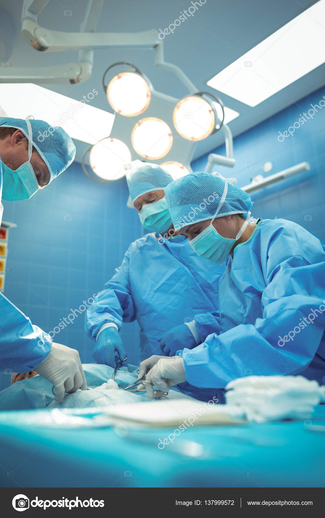 Surgeons performing operation in operation theater Stock Photo by ...