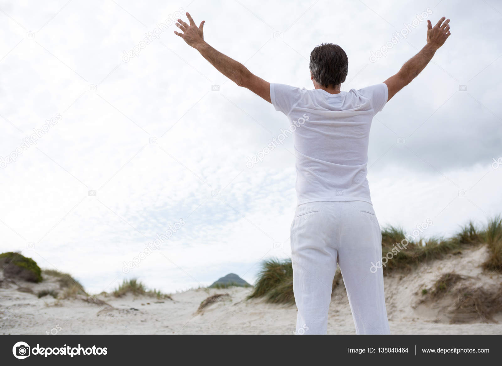 Man standing with arms outstretched on beach — Stock Photo ...