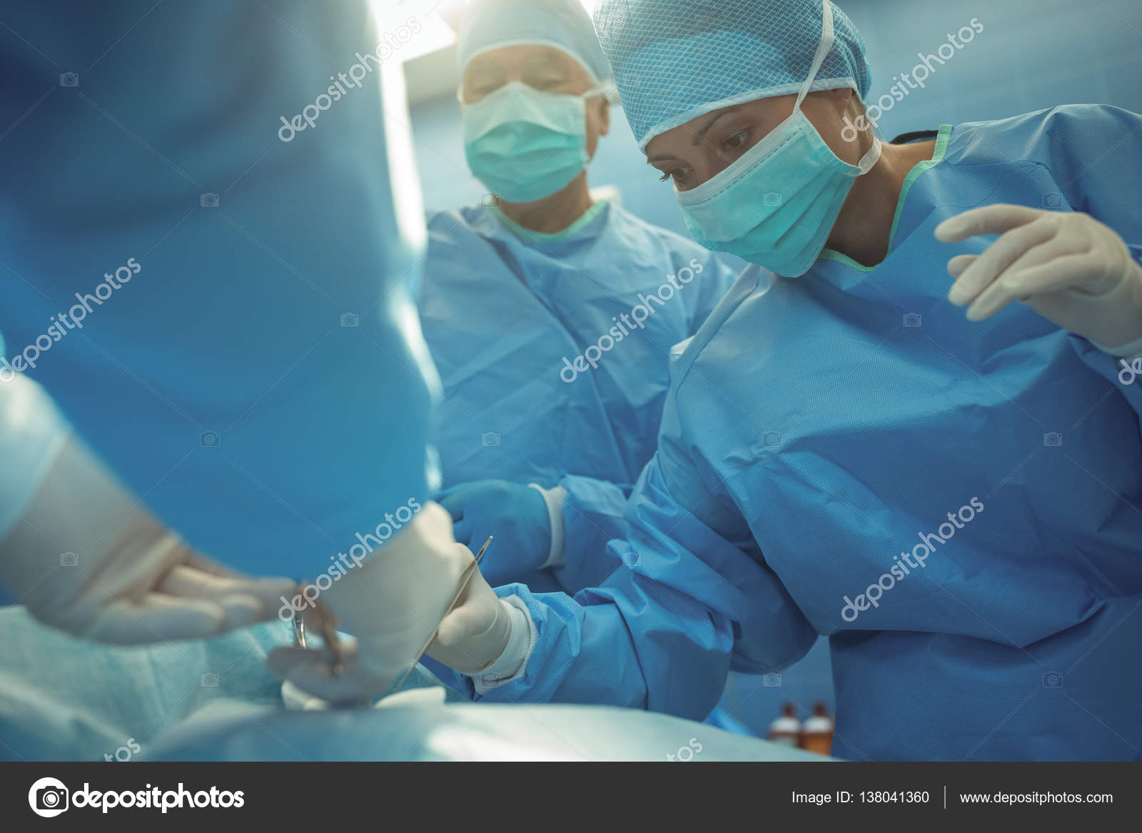 Surgeons performing operation in operation theater Stock Photo by ...
