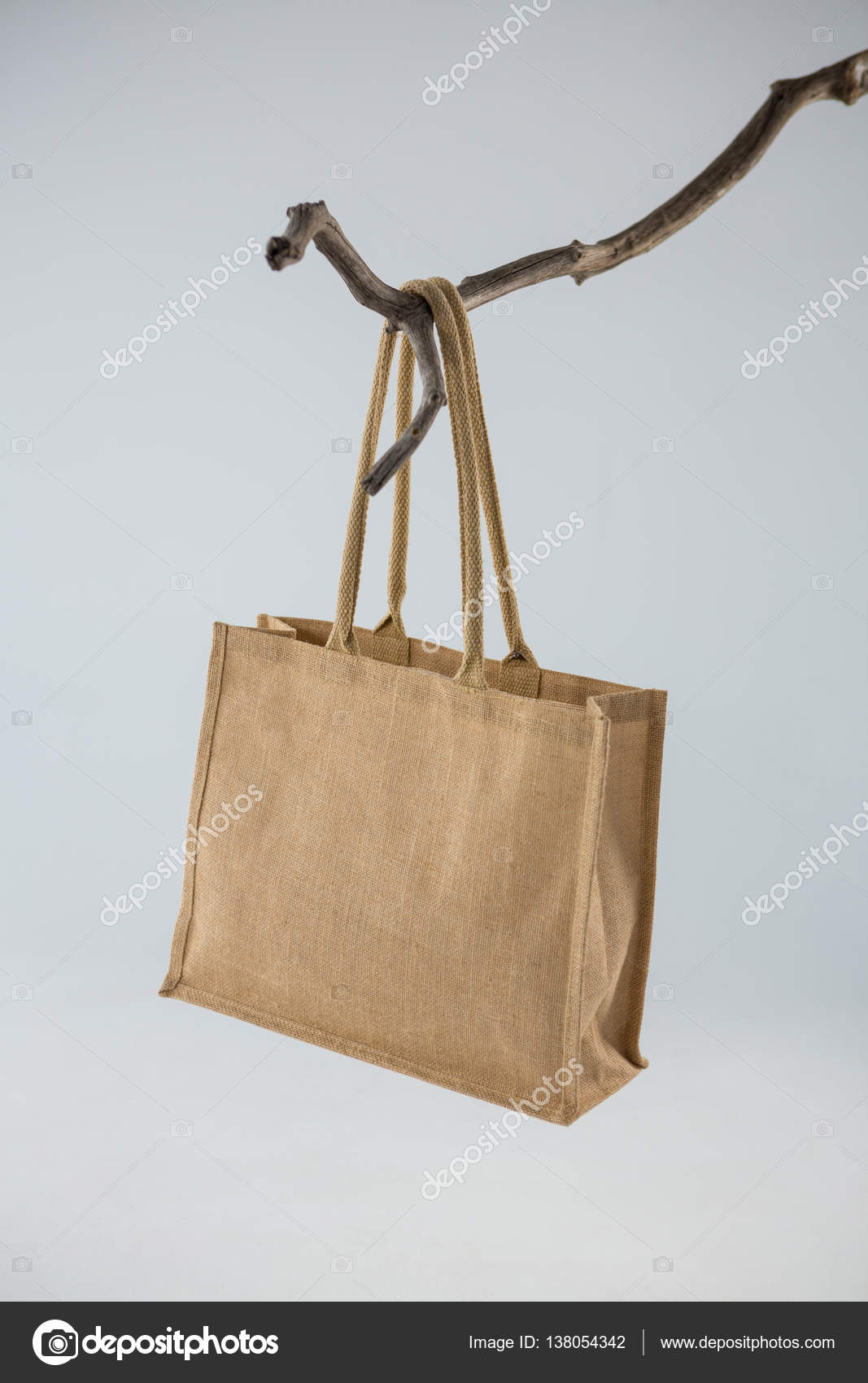 Jute bag hanging on a tree branch Stock Photo by ©Wavebreakmedia 138054342