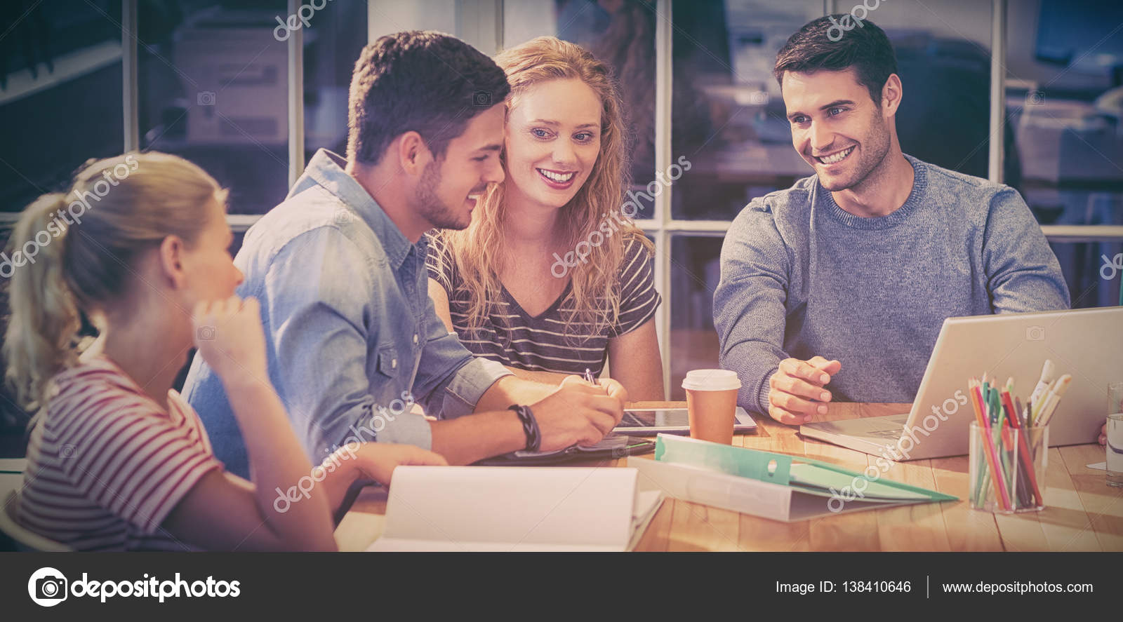 Group of young colleagues using laptop Stock Photo by ©Wavebreakmedia ...