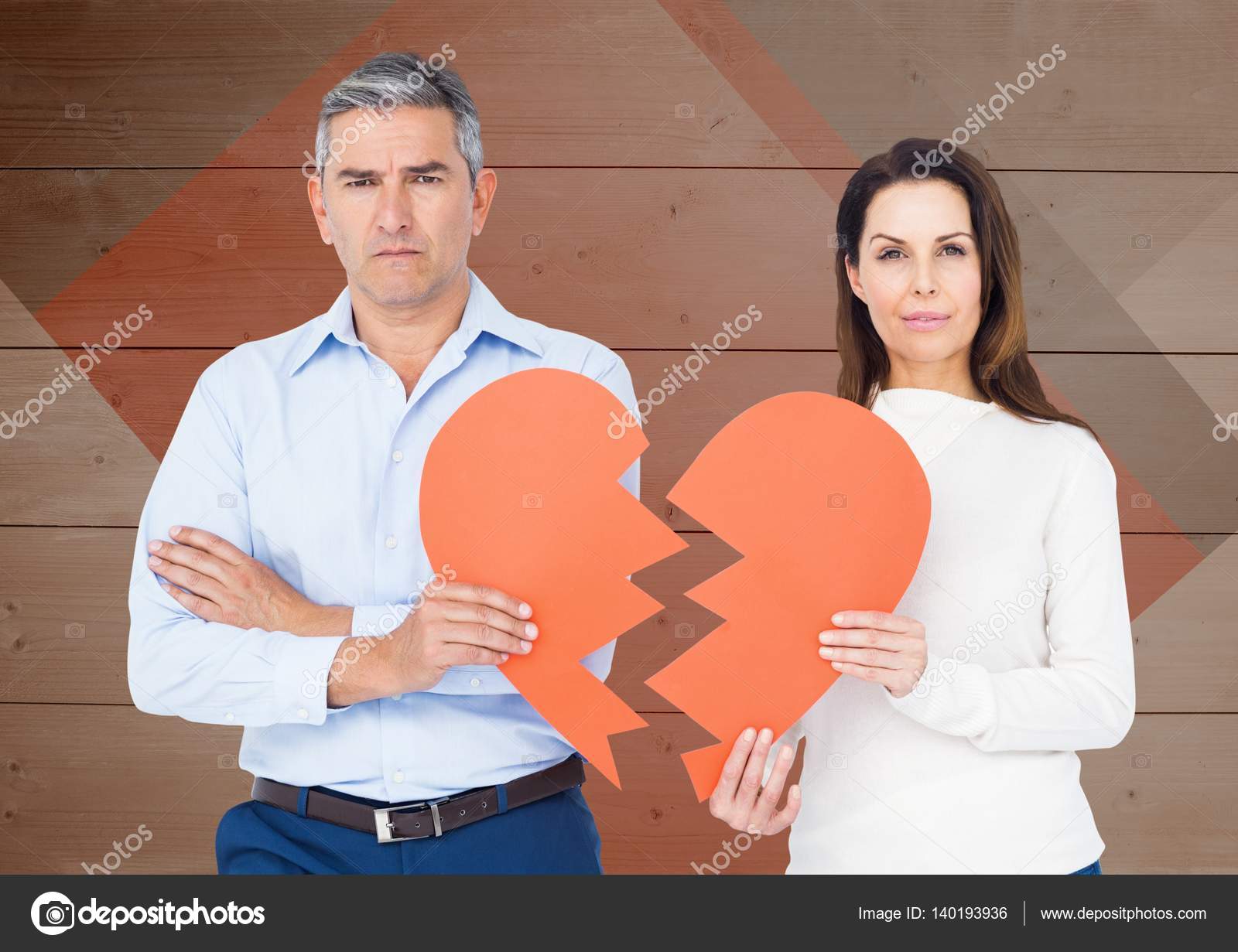 Sad couple holding broken hearts Stock Photo by ©Wavebreakmedia 140193936