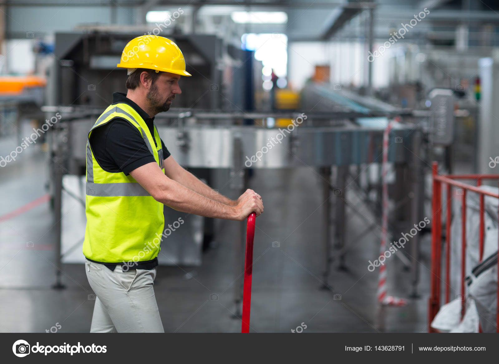 Factory worker pulling trolley in factory — Stock Photo ...