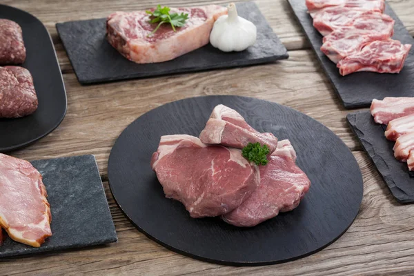 Varieties of meat on black tray — Stock Photo © Wavebreakmedia #143654533