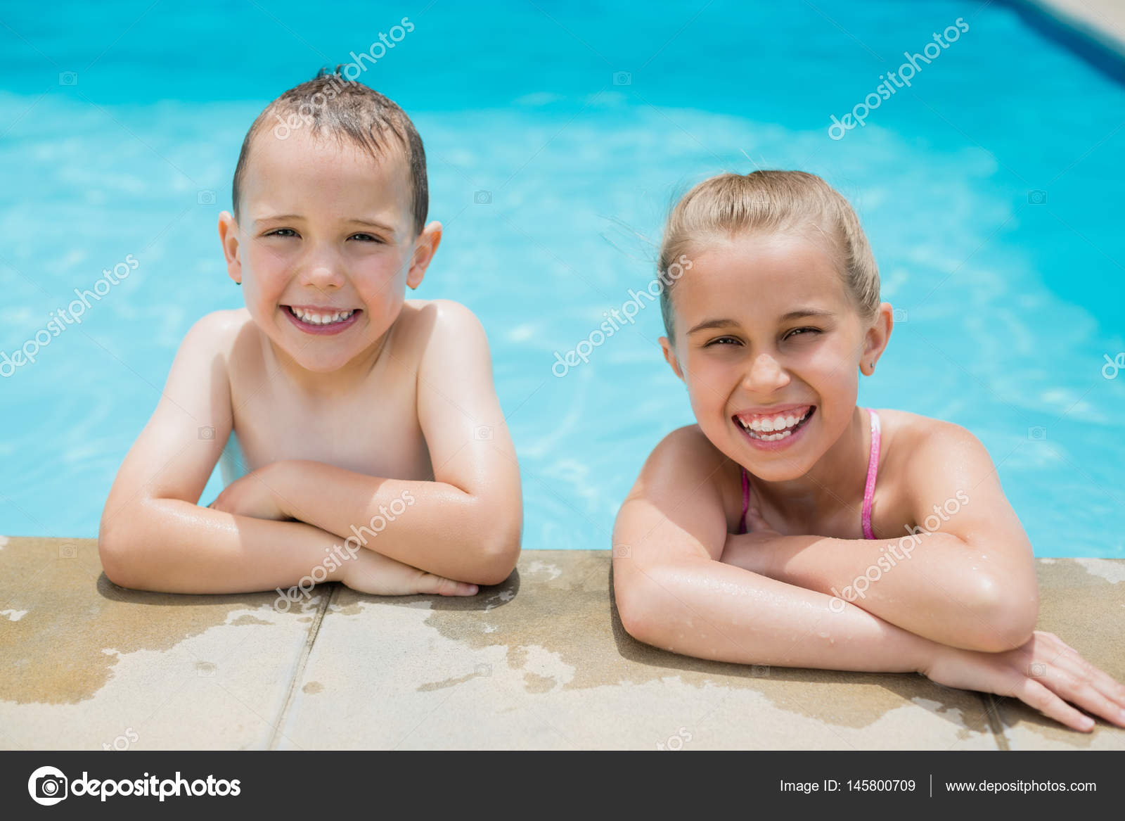 Boy and girl relaxing on swimming pool — Stock Photo © Wavebreakmedia ...