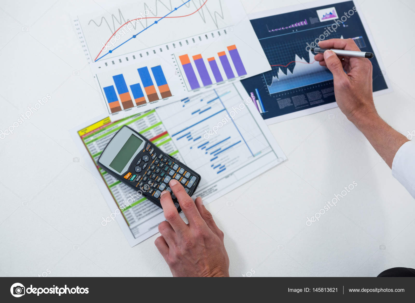 Hands calculating on graph Stock Photo by ©Wavebreakmedia 145813621