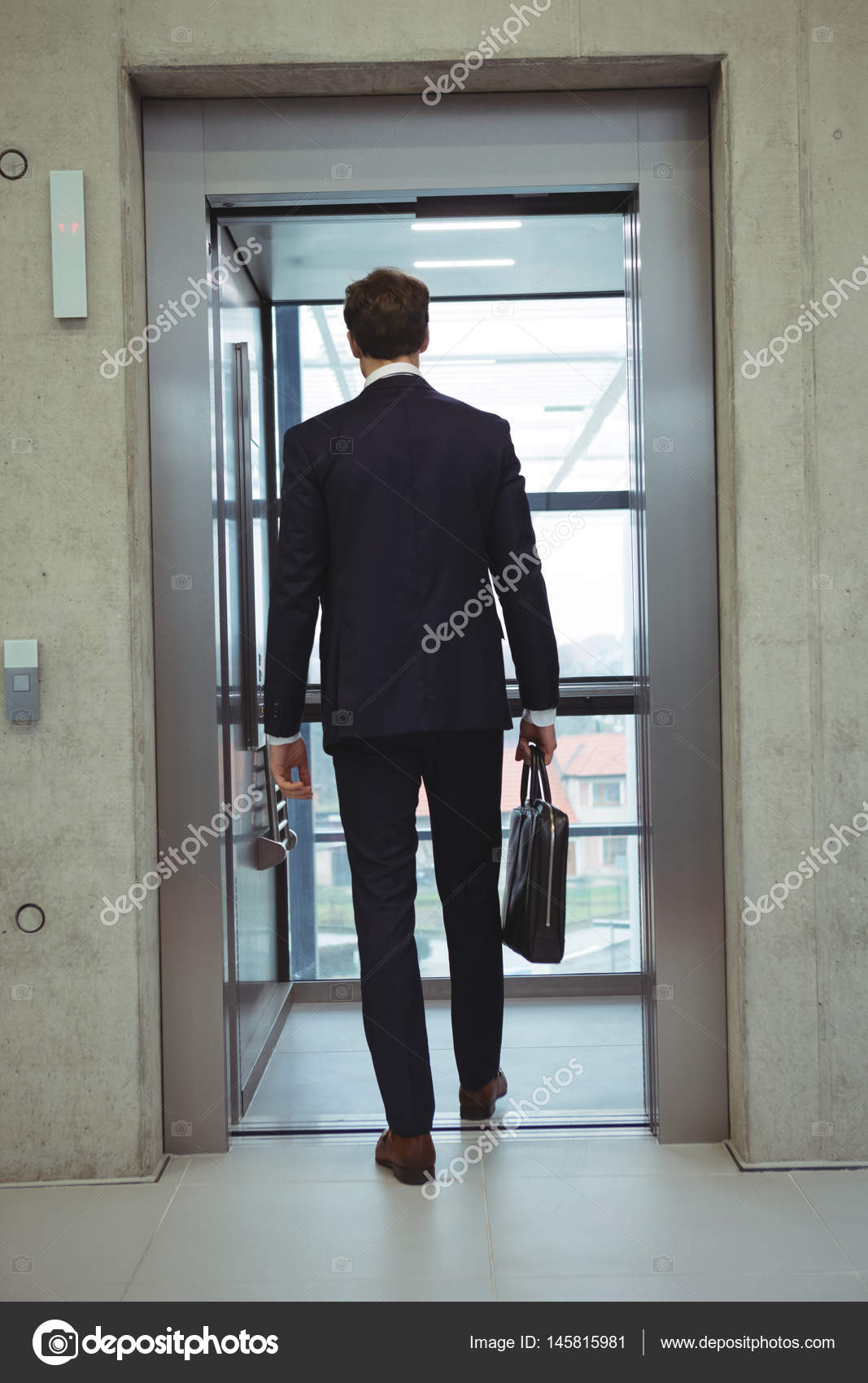 Businessman walking into an elevator — Stock Photo © Wavebreakmedia ... Businessman walking into an elevator — Stock Photo © Wavebreakmedia ...