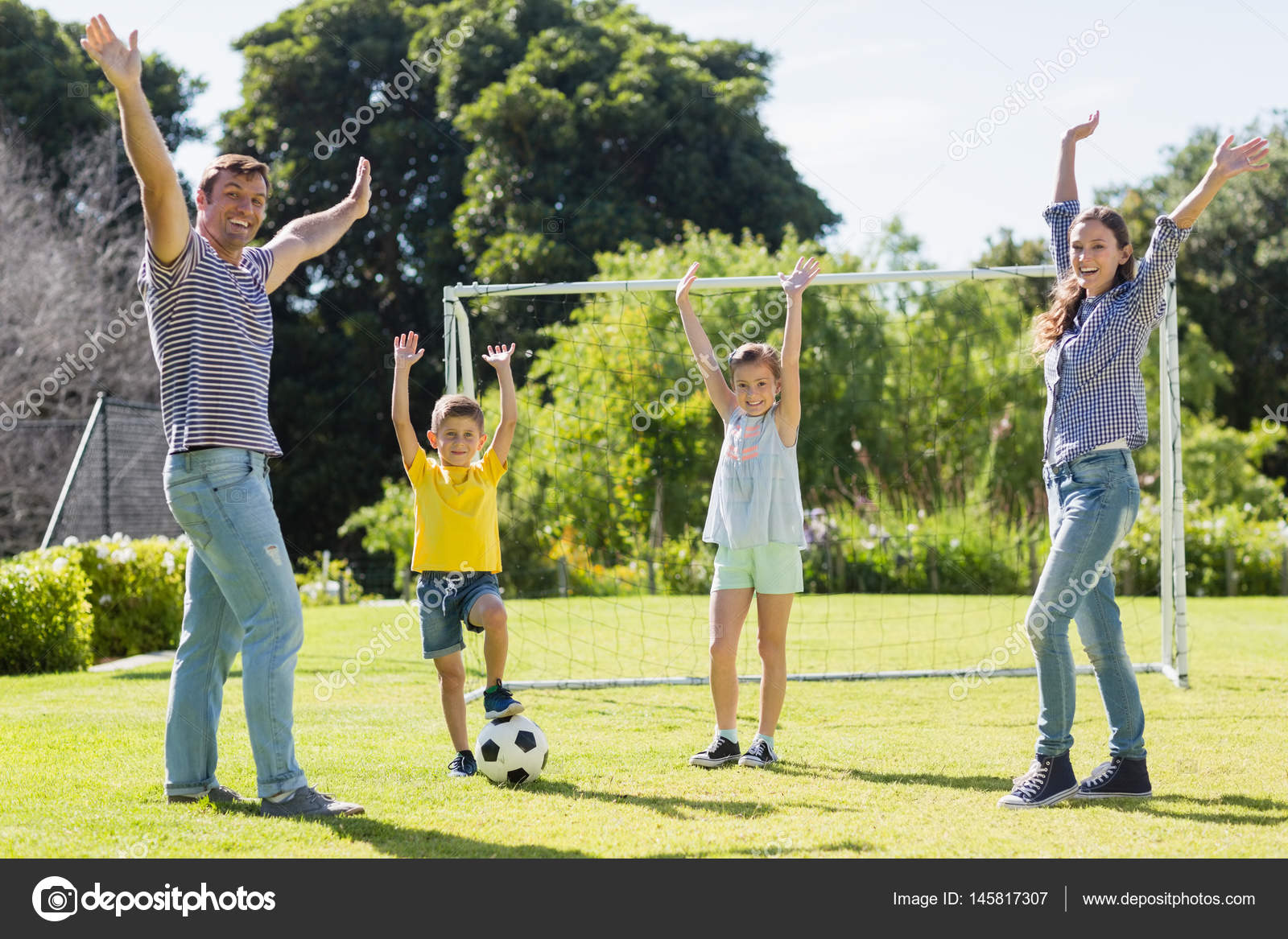 Family playing football together — Stock Photo © Wavebreakmedia #145817307
