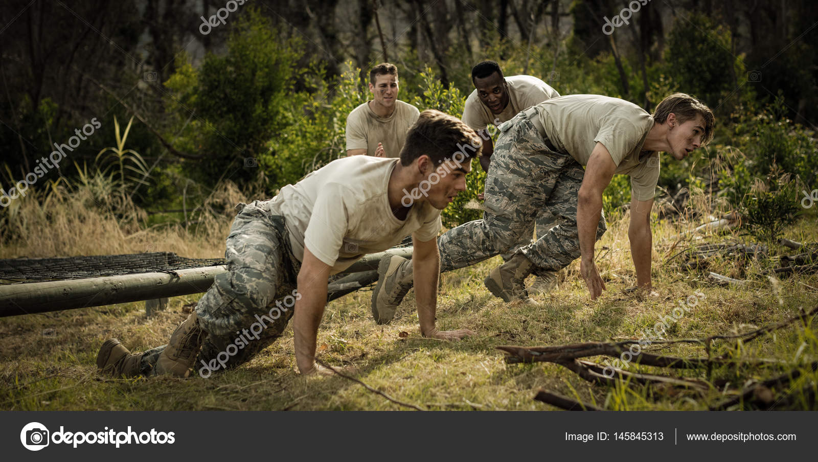 Soldiers crawling under the net during obstacle course Stock Photo by ...