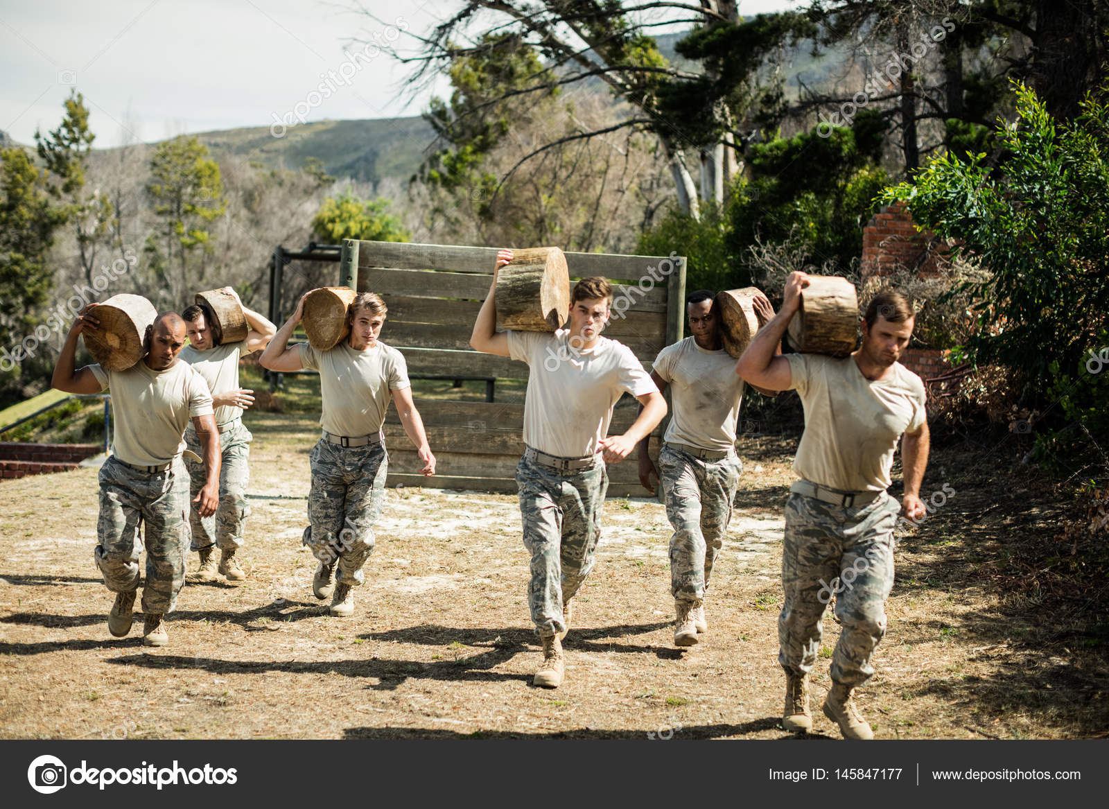 Soldiers carrying a tree log — Stock Photo © Wavebreakmedia #145847177