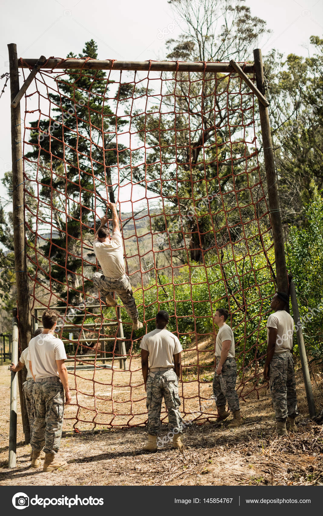 Military soldier climbing rope during obstacle course Stock Photo by ...