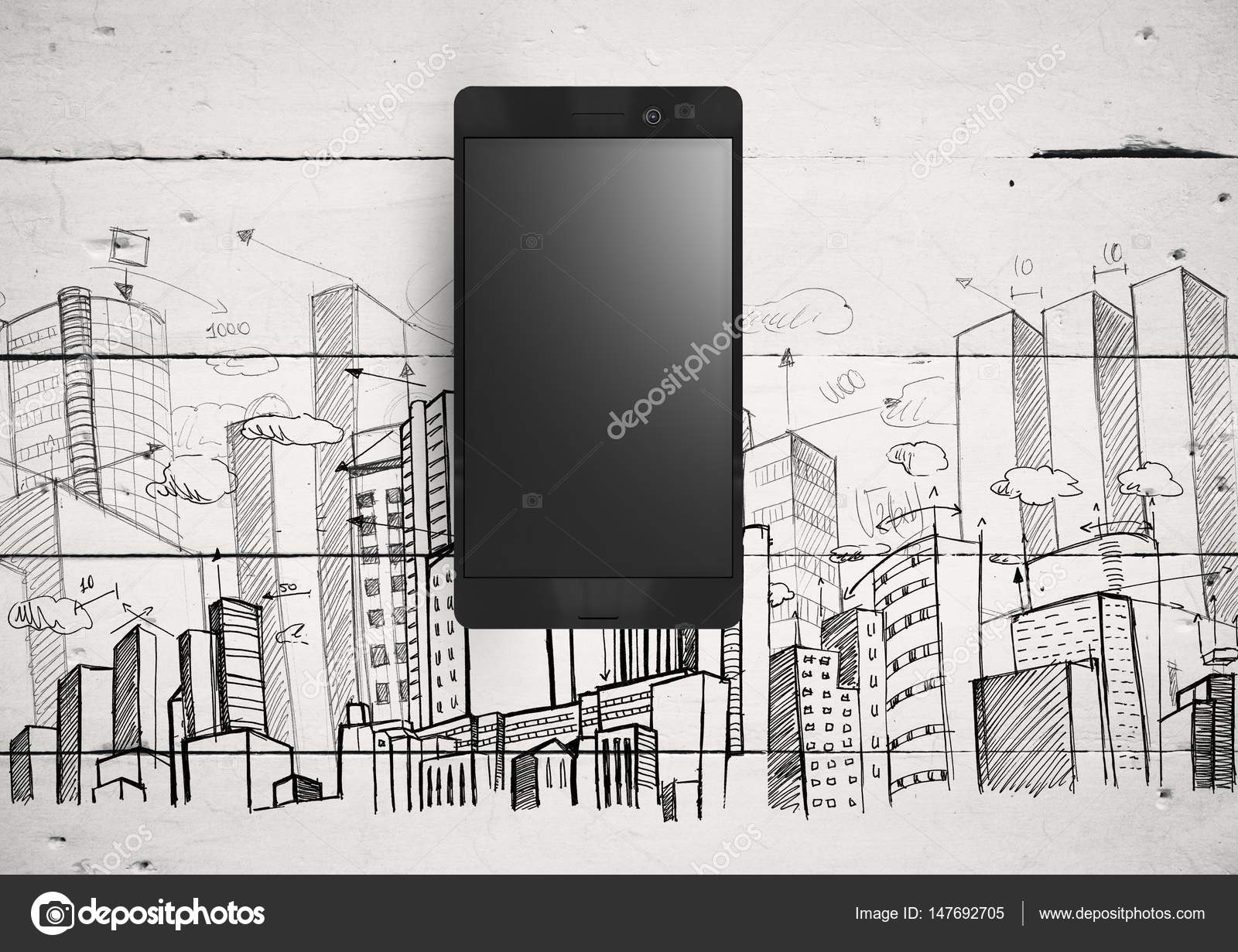 Phone against white wood background with City buildings drawings ...
