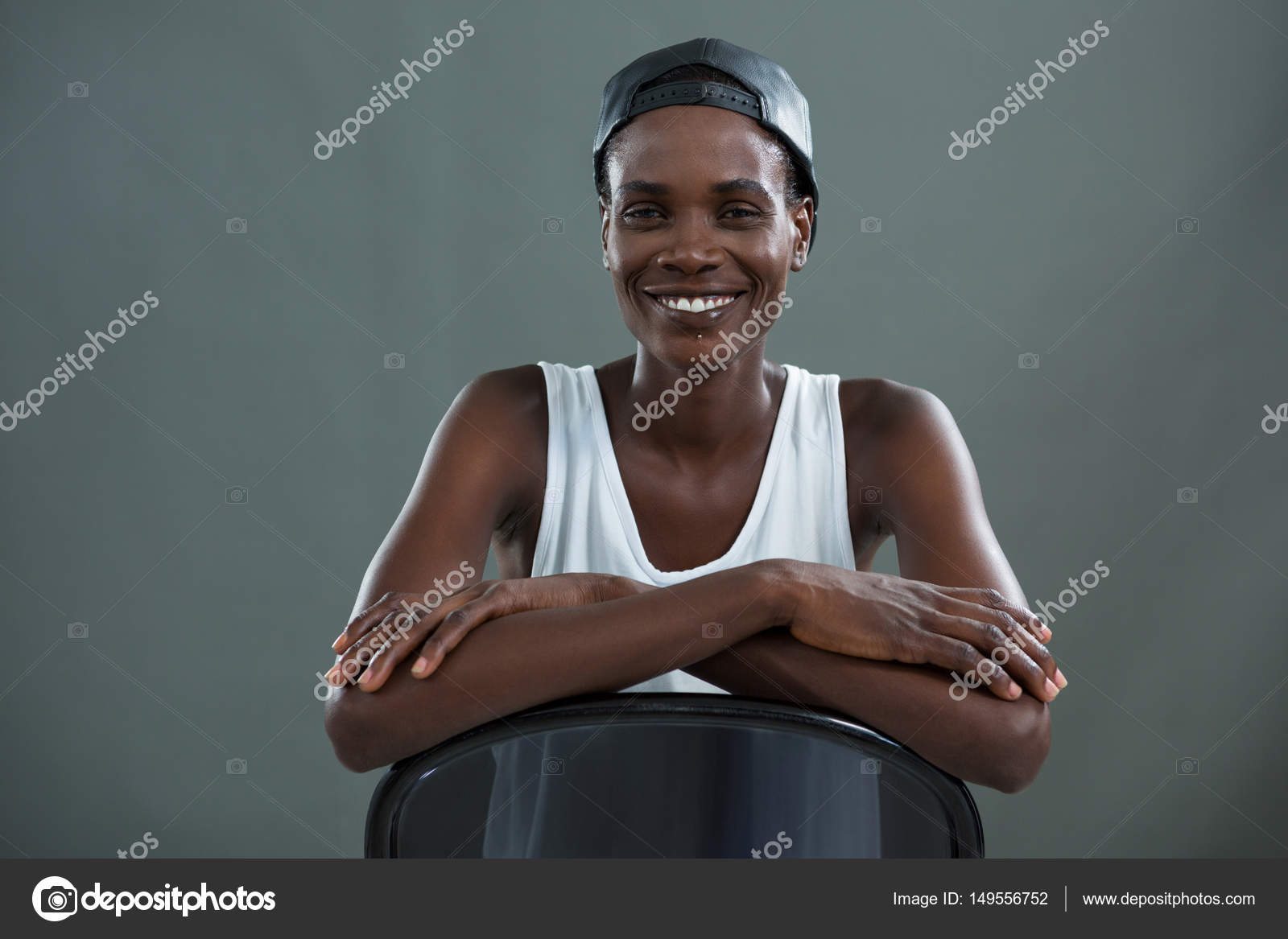 Androgynous man in cap smiling Stock Photo by ©Wavebreakmedia 149556752
