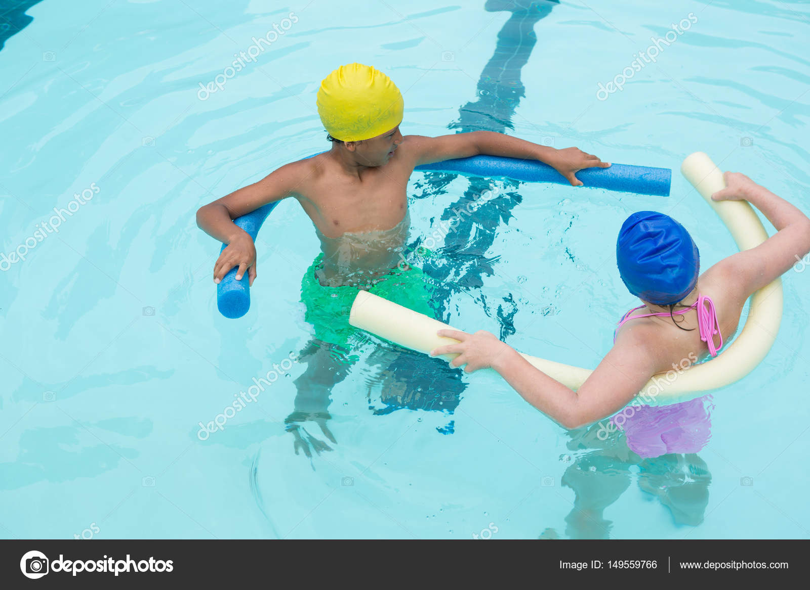 Two kids swimming in pool Stock Photo by ©Wavebreakmedia 149559766