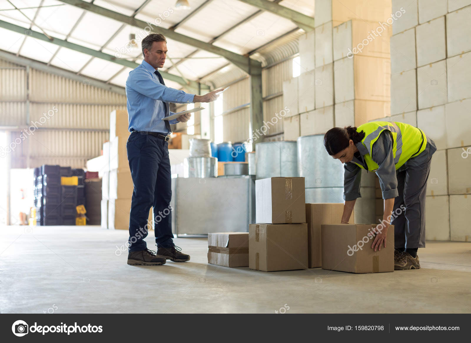 Manager instructing female worker while working — Stock Photo ...