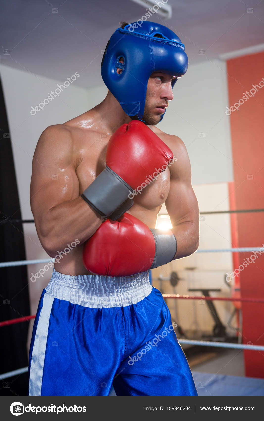 Boxer wearing blue headgear Stock Photo by ©Wavebreakmedia 159946284