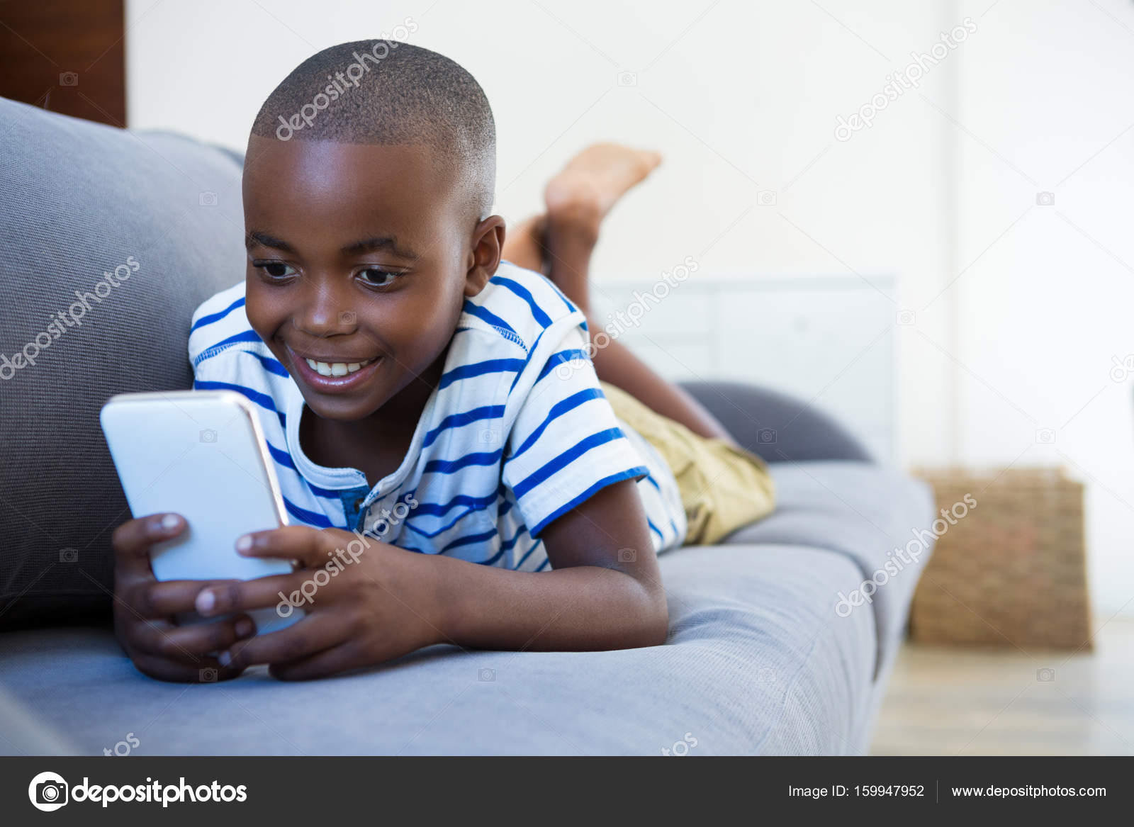 Boy using mobile phone Stock Photo by ©Wavebreakmedia 159947952
