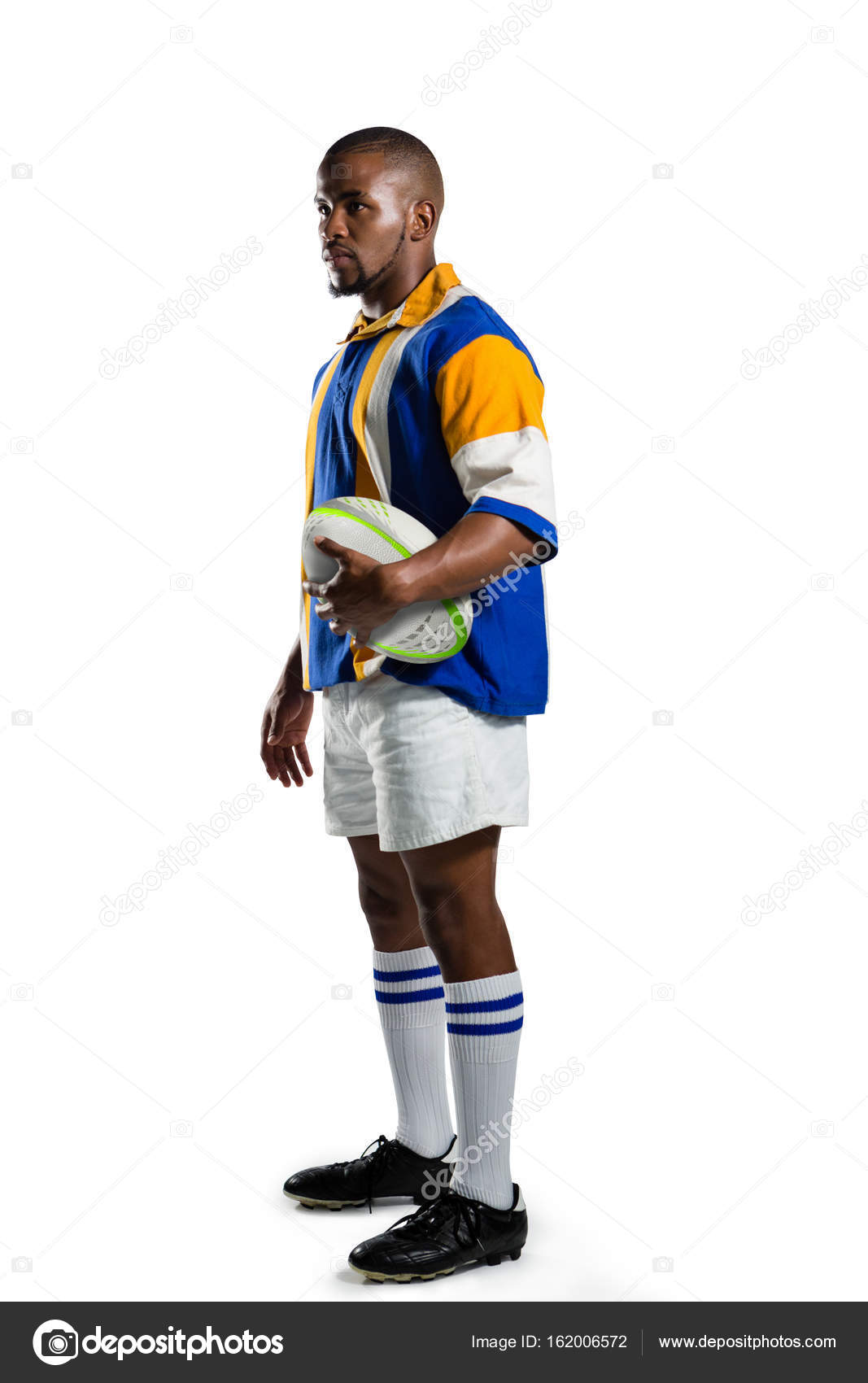 Confident rugby player holding ball Stock Photo by ©Wavebreakmedia ...