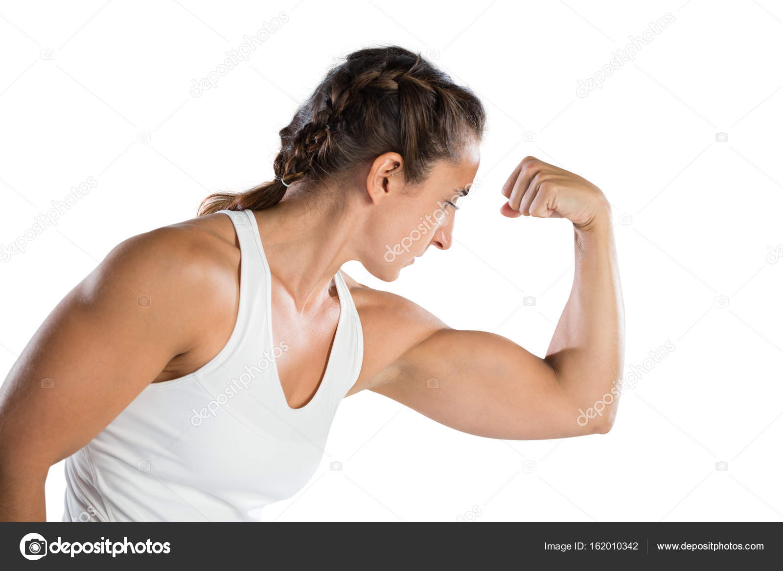 Female athlete flexing muscles Stock Photo by ©Wavebreakmedia 162010342
