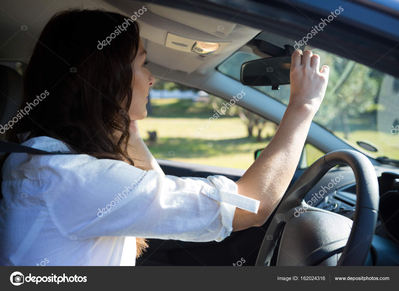Woman looking into rear view mirror Stock Photo by ©Wavebreakmedia ...